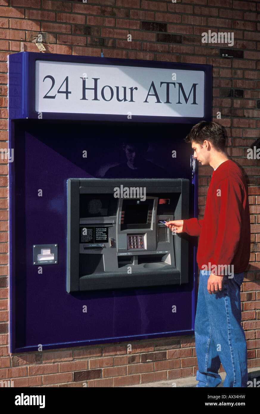 Young Man Inserting Debit Card into Automated Teller Machine in Order ...