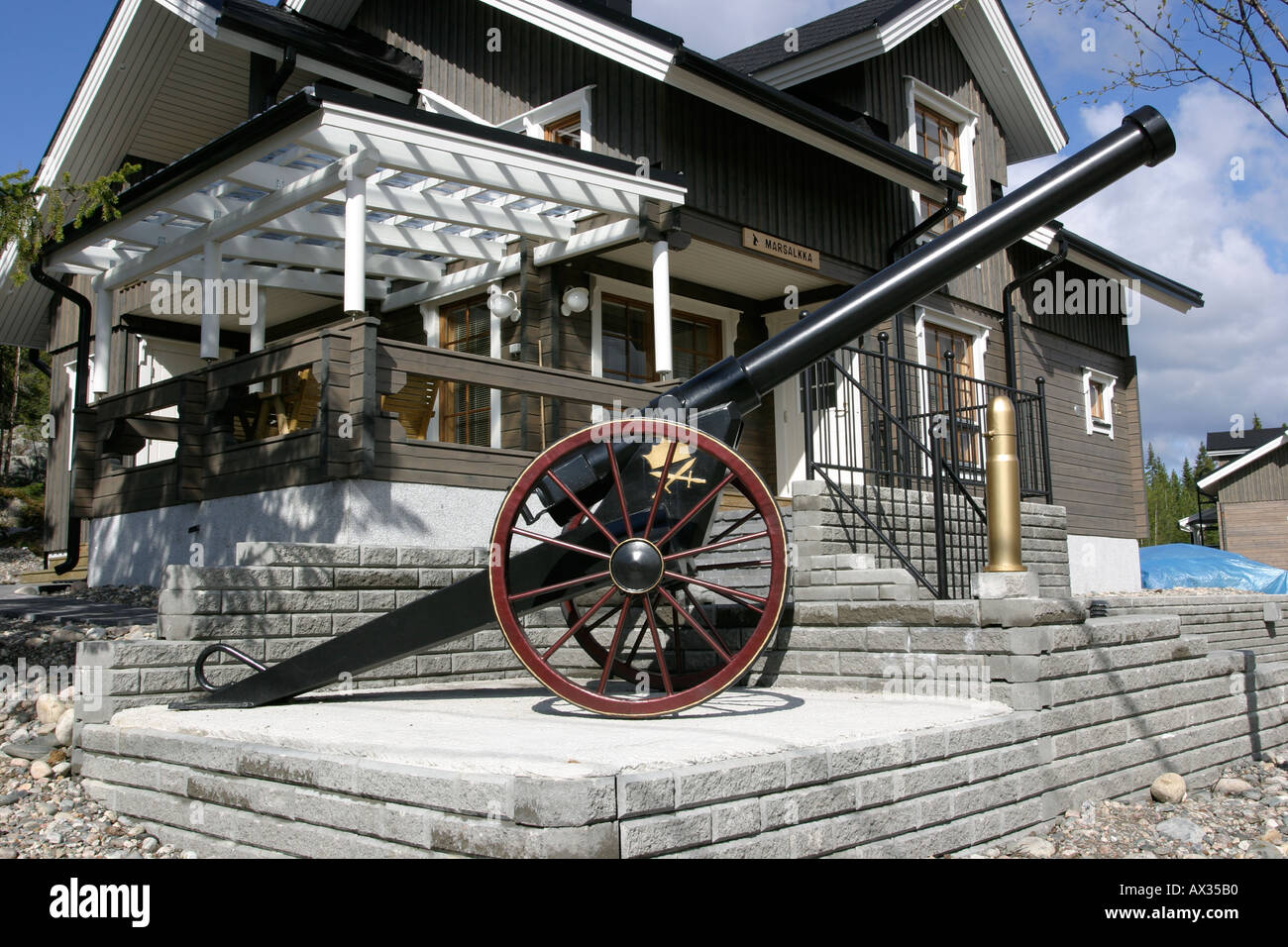 Decoration cannon in front of cottage Stock Photo - Alamy
