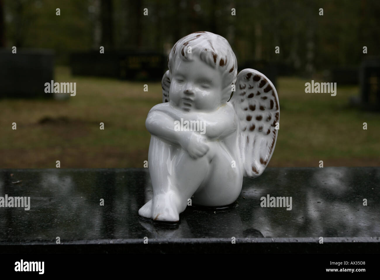 small angel statue on a grave Stock Photo - Alamy