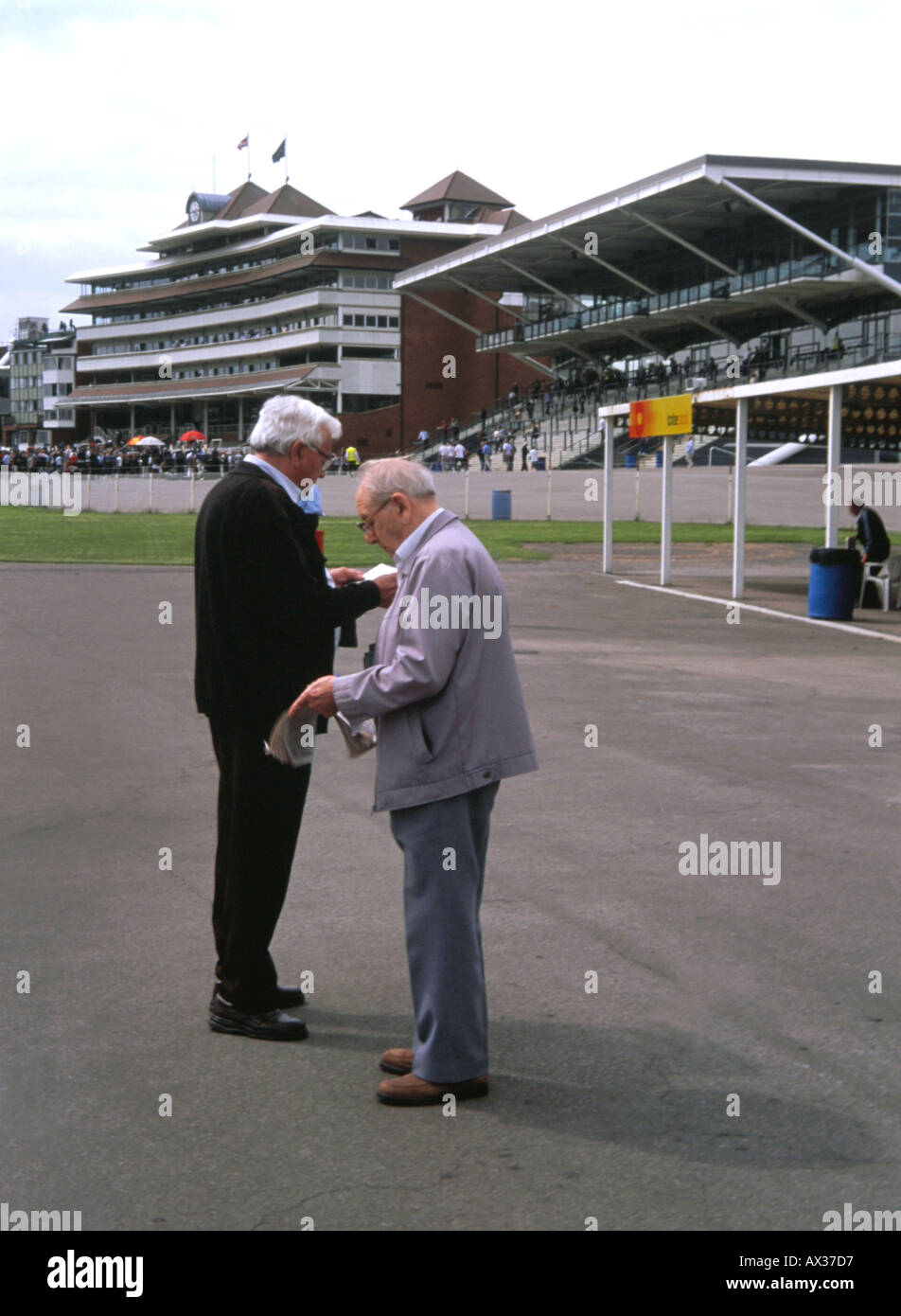 Two men at horse race racing meeting Stock Photo - Alamy