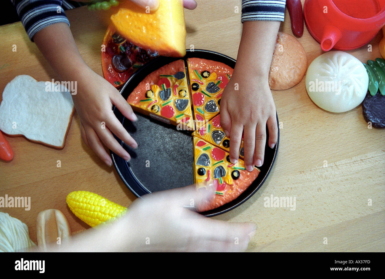 Children playing with plastic food in classroom Stock Photo - Alamy