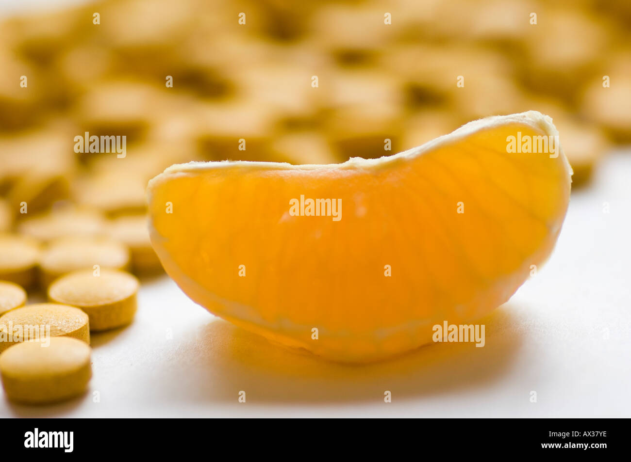slice of Clementine with pills Stock Photo - Alamy