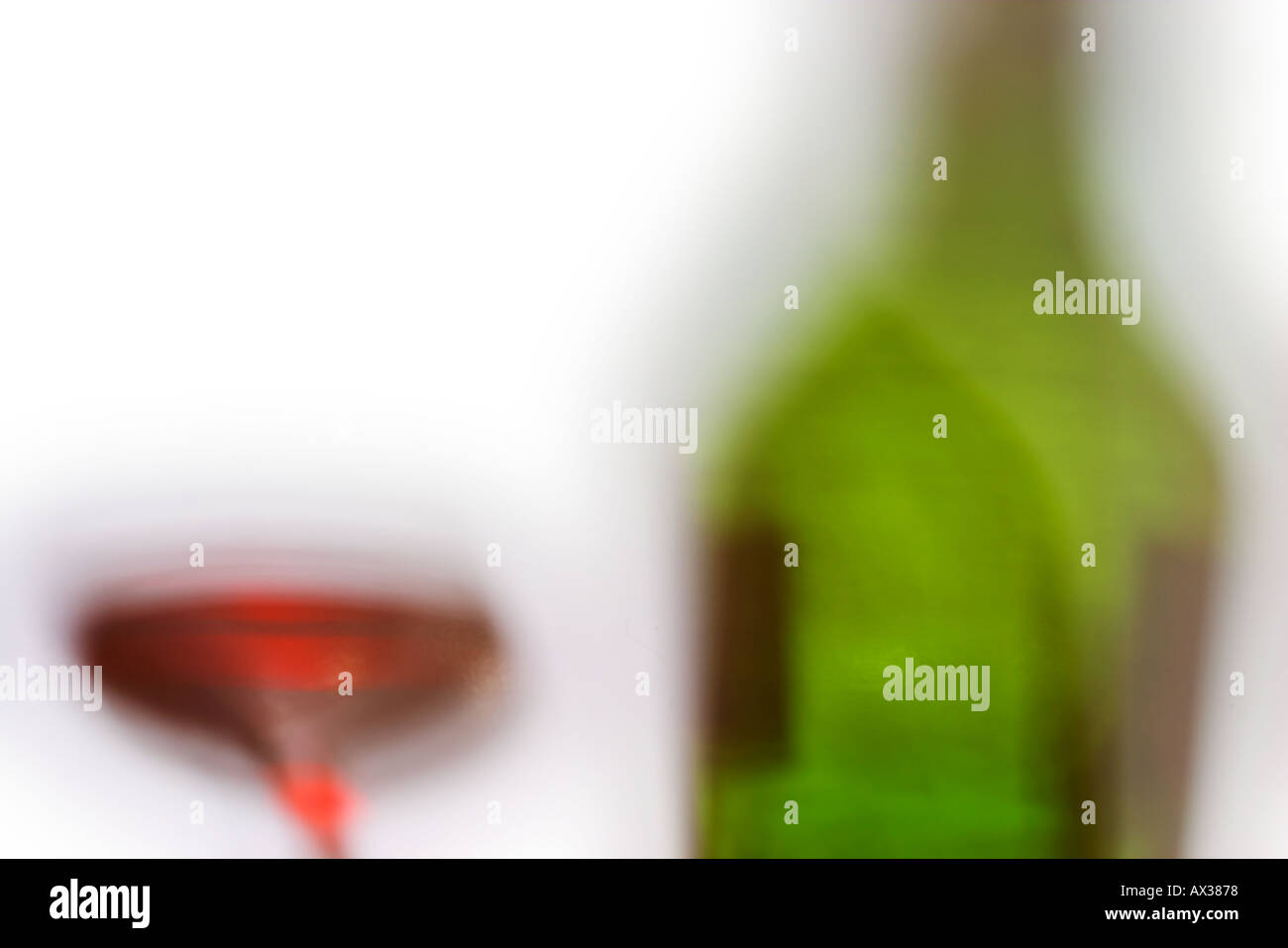 Wine bottle and glass of red sunlight projected through abstract ...