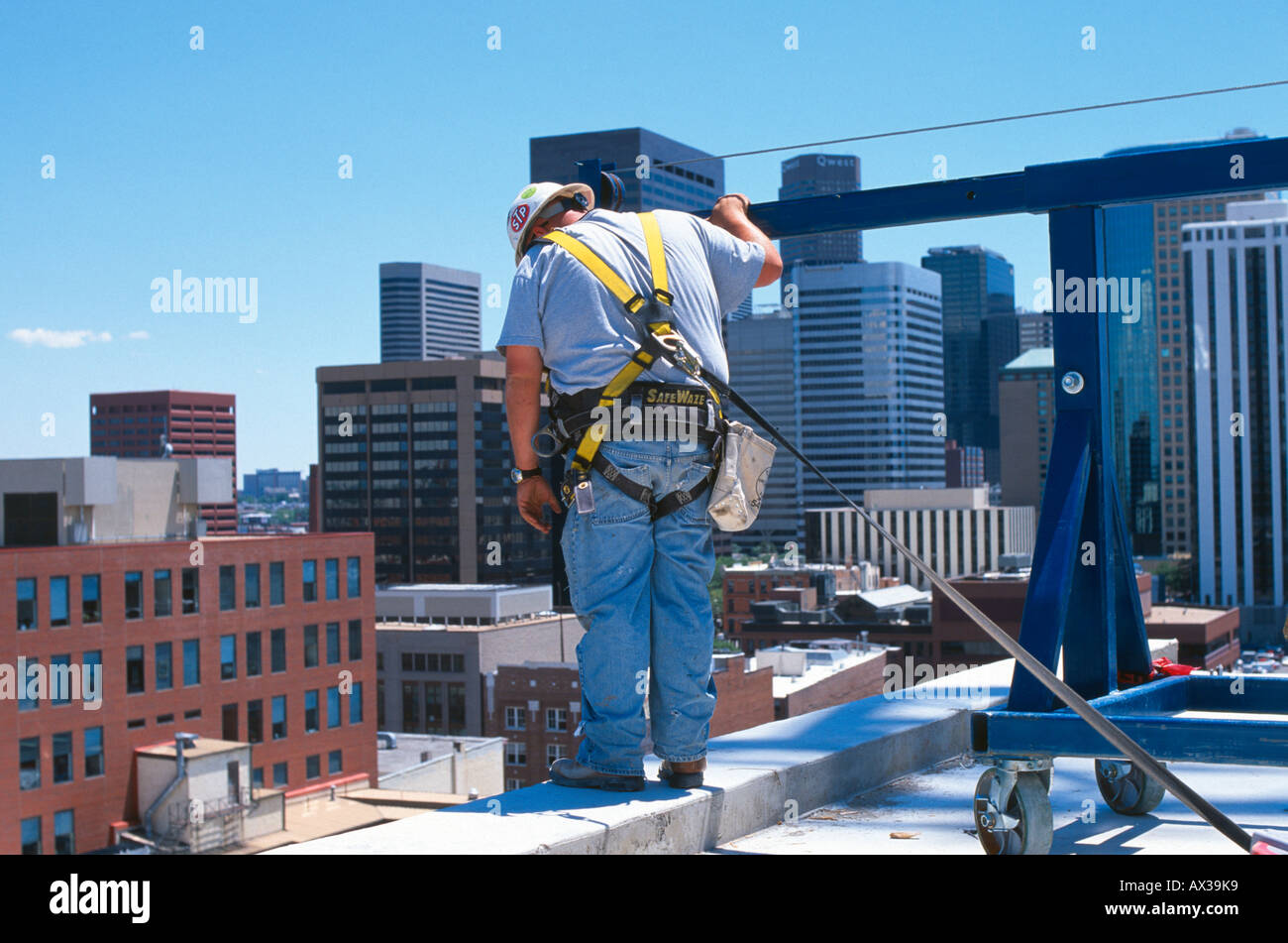 Construction worker on roof of high rise building Denver Colorado USA ...