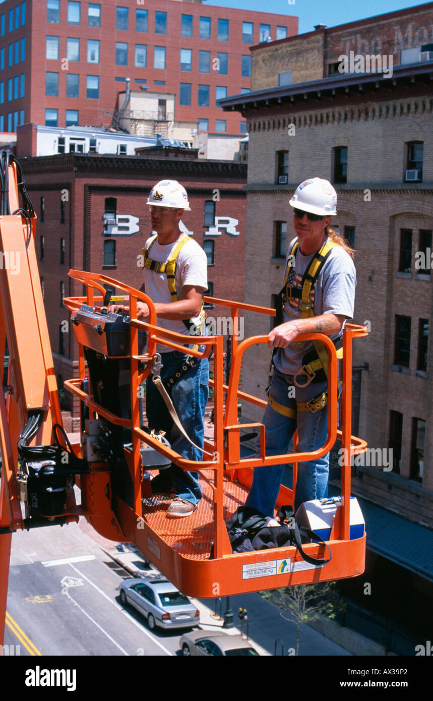 Construction workers in cherry picker outside high rise building Denver ...