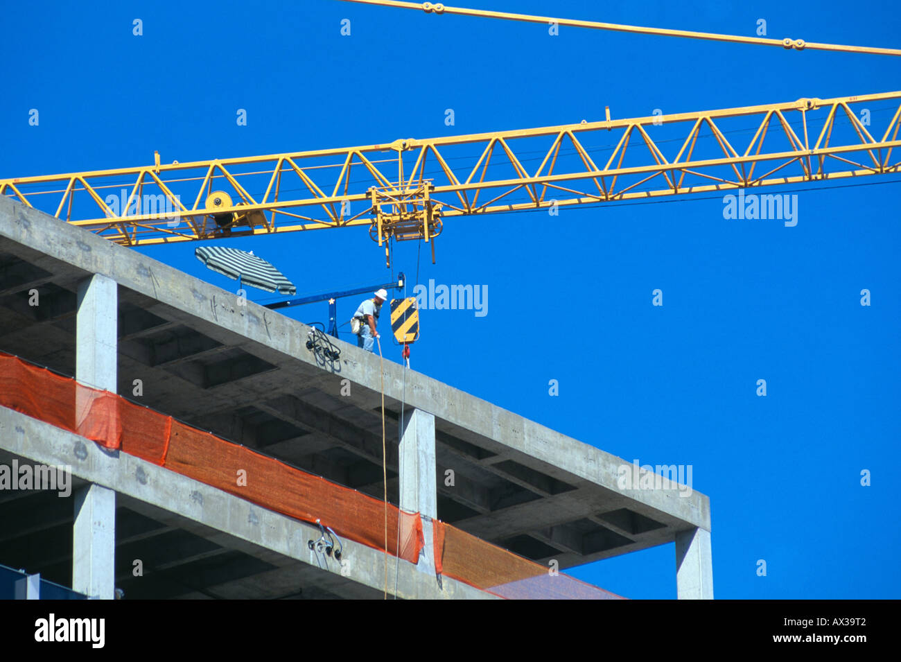 Construction worker on roof of high rise building Denver Colorado USA ...