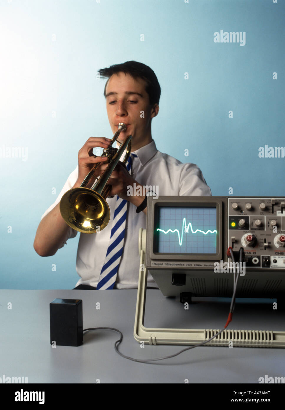 A school boy plays a note on a trumpet and its waveform via a ...