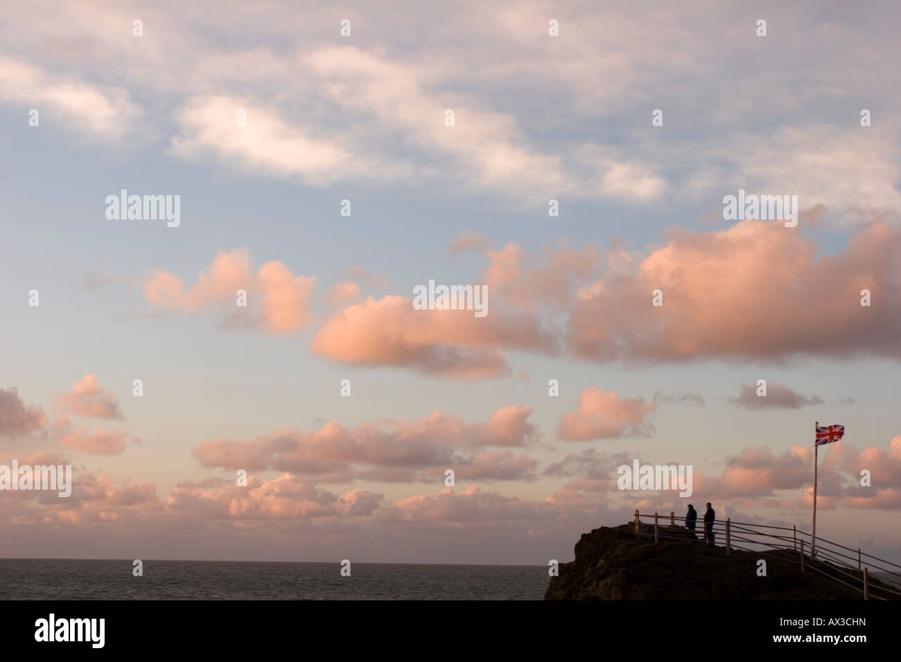 Ocean sunset with Union jack flag and silouhetted people Stock Photo ...
