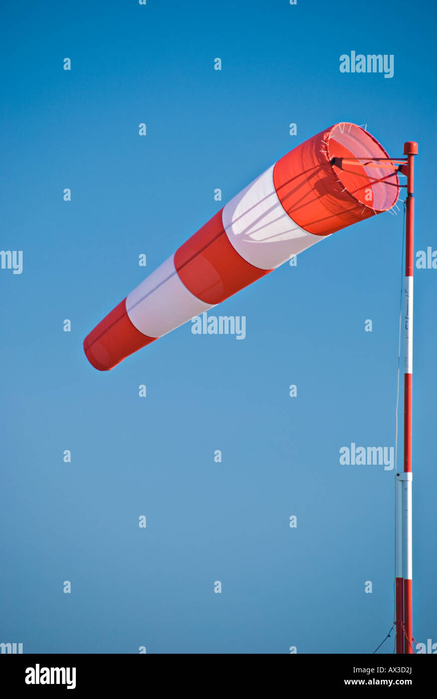 Windsock fluttering in the wind in a blue sky Stock Photo - Alamy