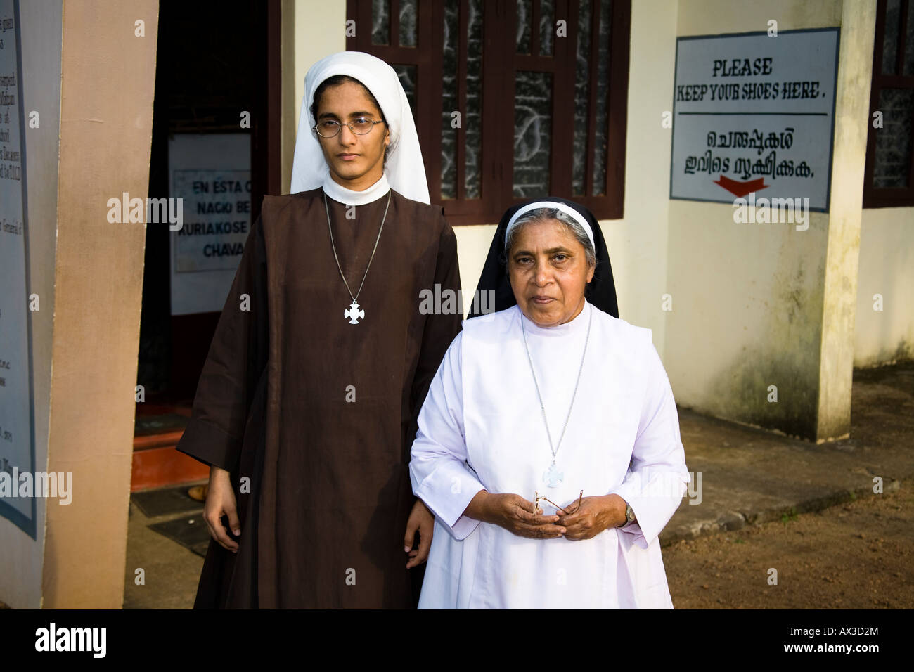 Two nuns standing outside Chavarabhavan Church, Kainakary village ...
