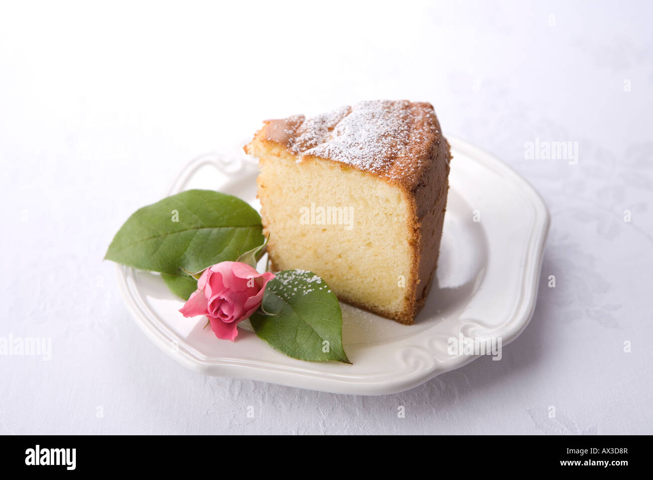 Cake slice on plate with & rose Stock Photo - Alamy