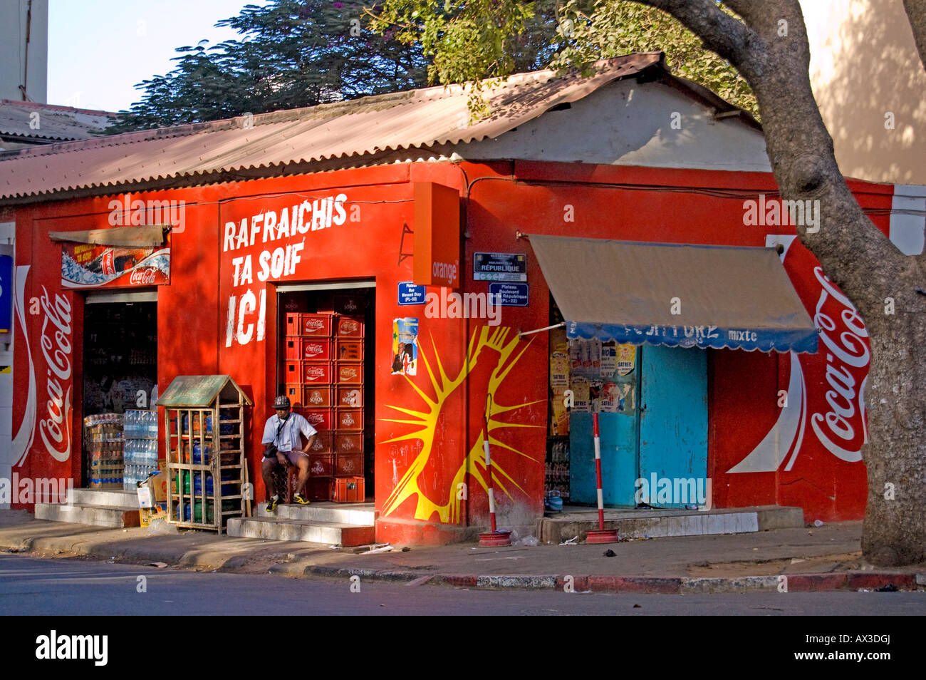 Senegal. Dakar. Young man shopkeeper sitting outside corner store Stock ...