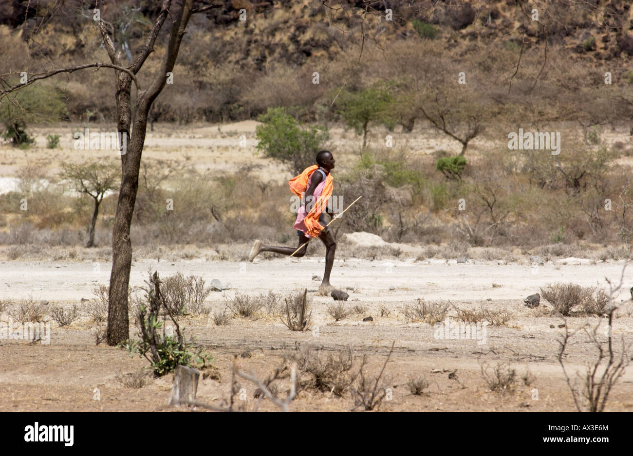 Maasai Masai running through the bush Stock Photo - Alamy