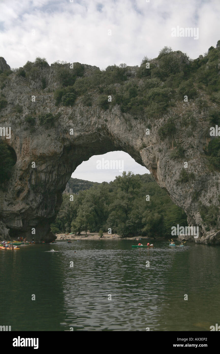Canoe kayak and canoeist Pont d'Arc natural stone rock arch Ardeche ...