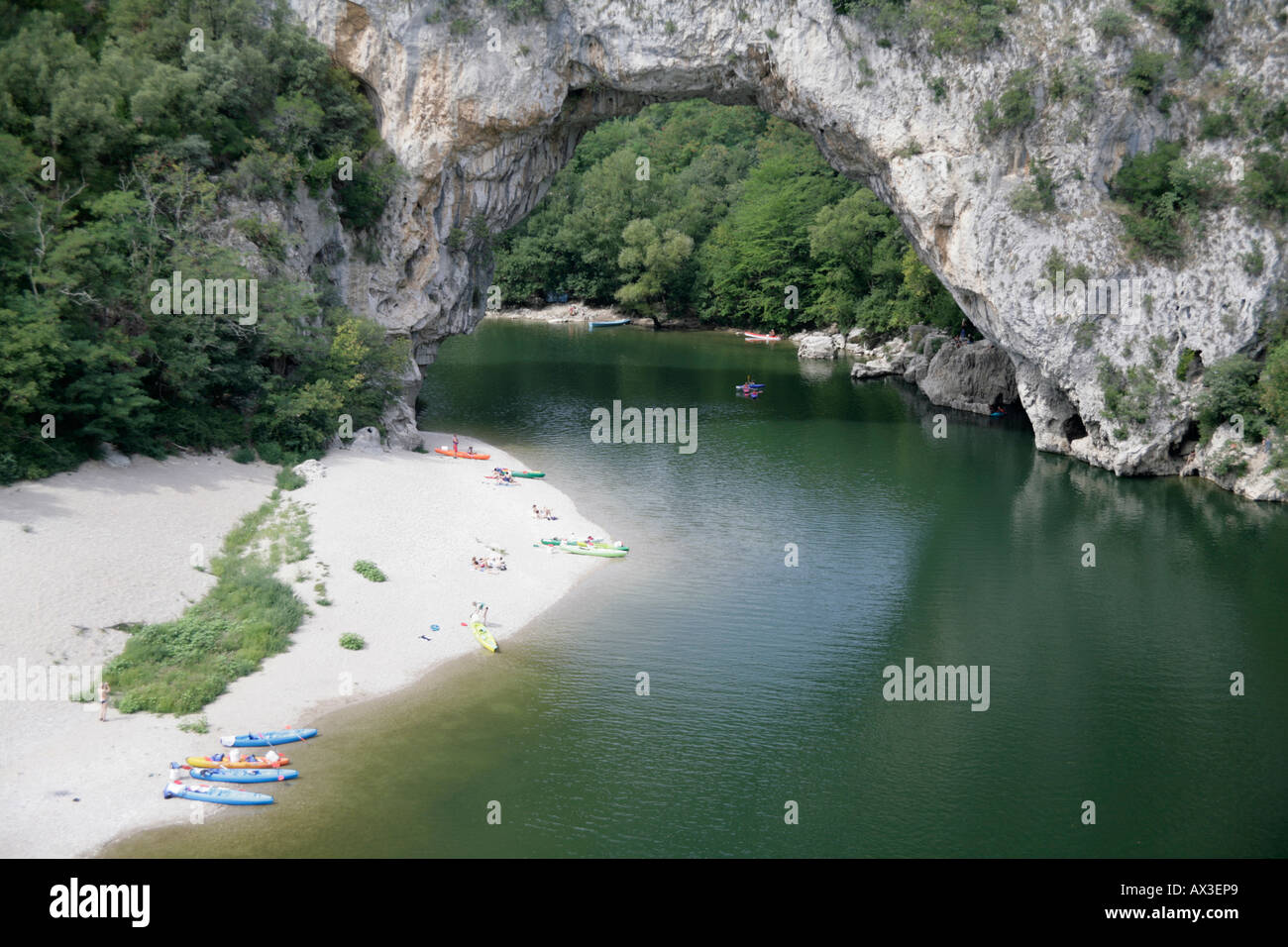Canoe kayak and canoeist Pont d'Arc natural stone rock arch Ardeche ...