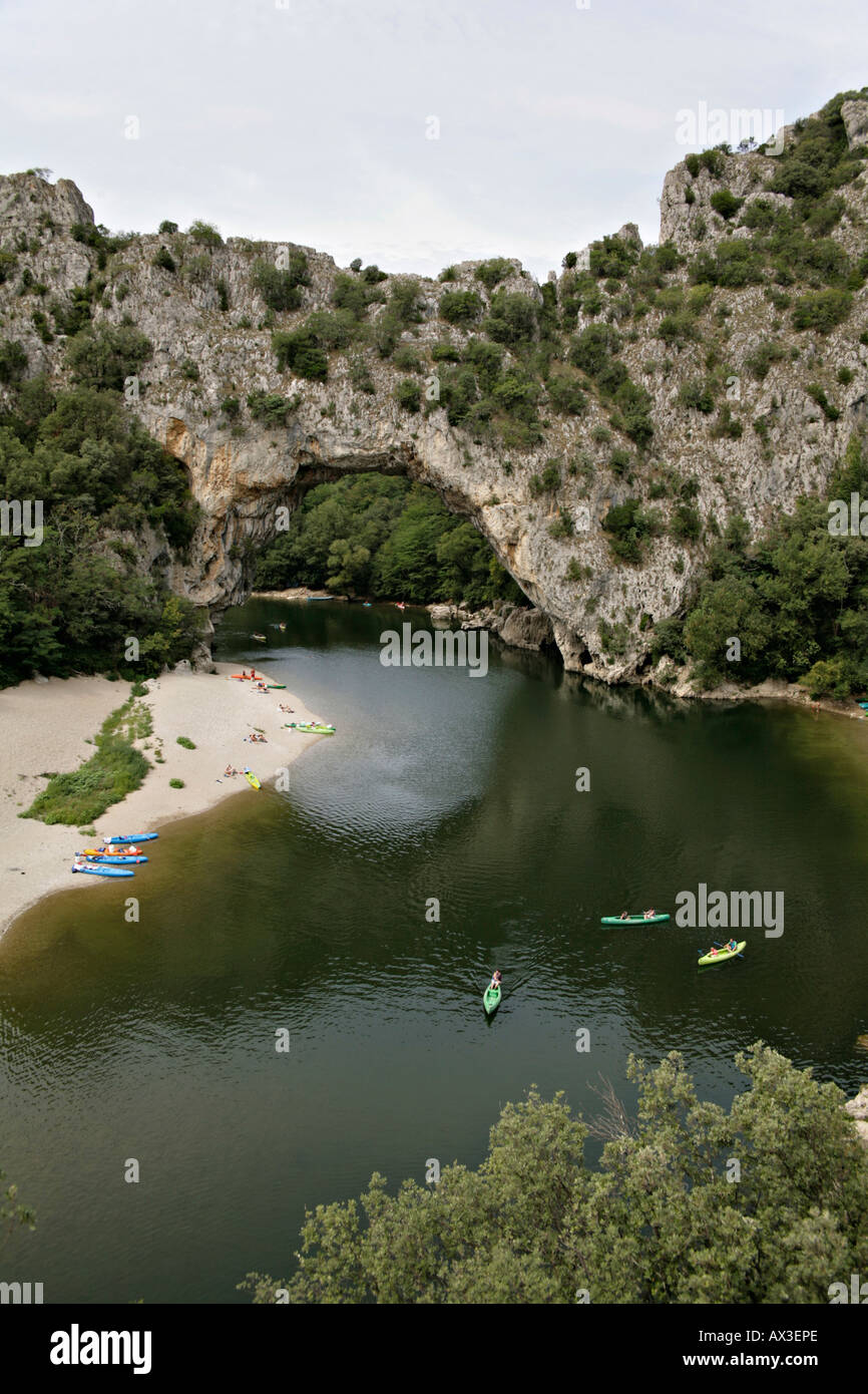Canoe kayak and canoeist Pont d'Arc natural stone rock arch Ardeche ...