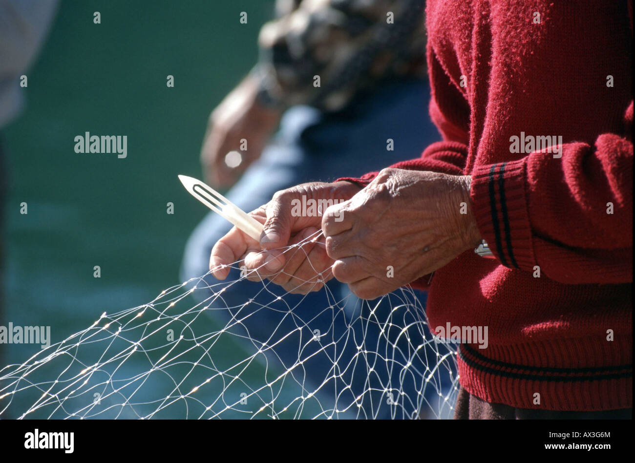 Hands mending fishing nets hi-res stock photography and images - Alamy
