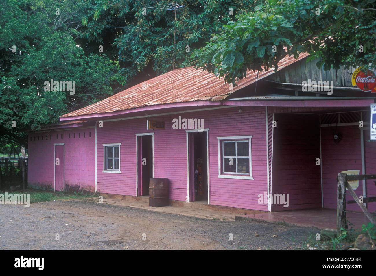 Brightly coloured wood and tin store at the roadside in rural Costa ...