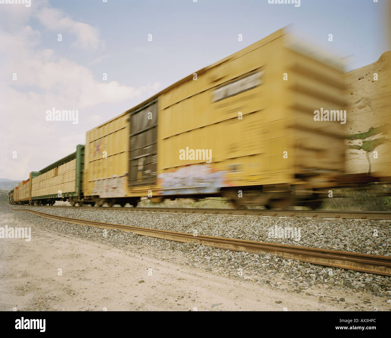 Freight train in motion Stock Photo - Alamy