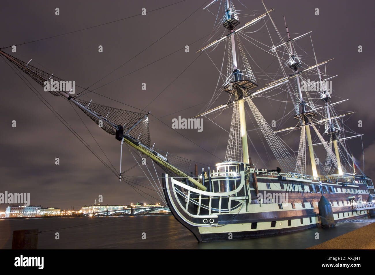 Russian ship in the night lights and bridge on background St Petersburg ...