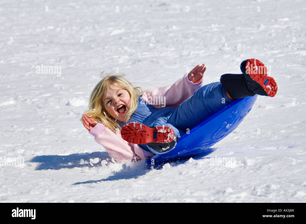 Female children sledding hi-res stock photography and images - Alamy
