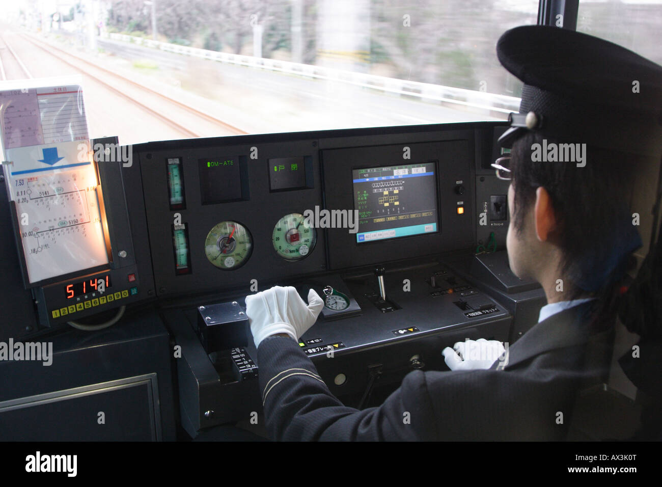 A train driver in a Japanese commuter train, Tokyo, Japan Stock Photo ...