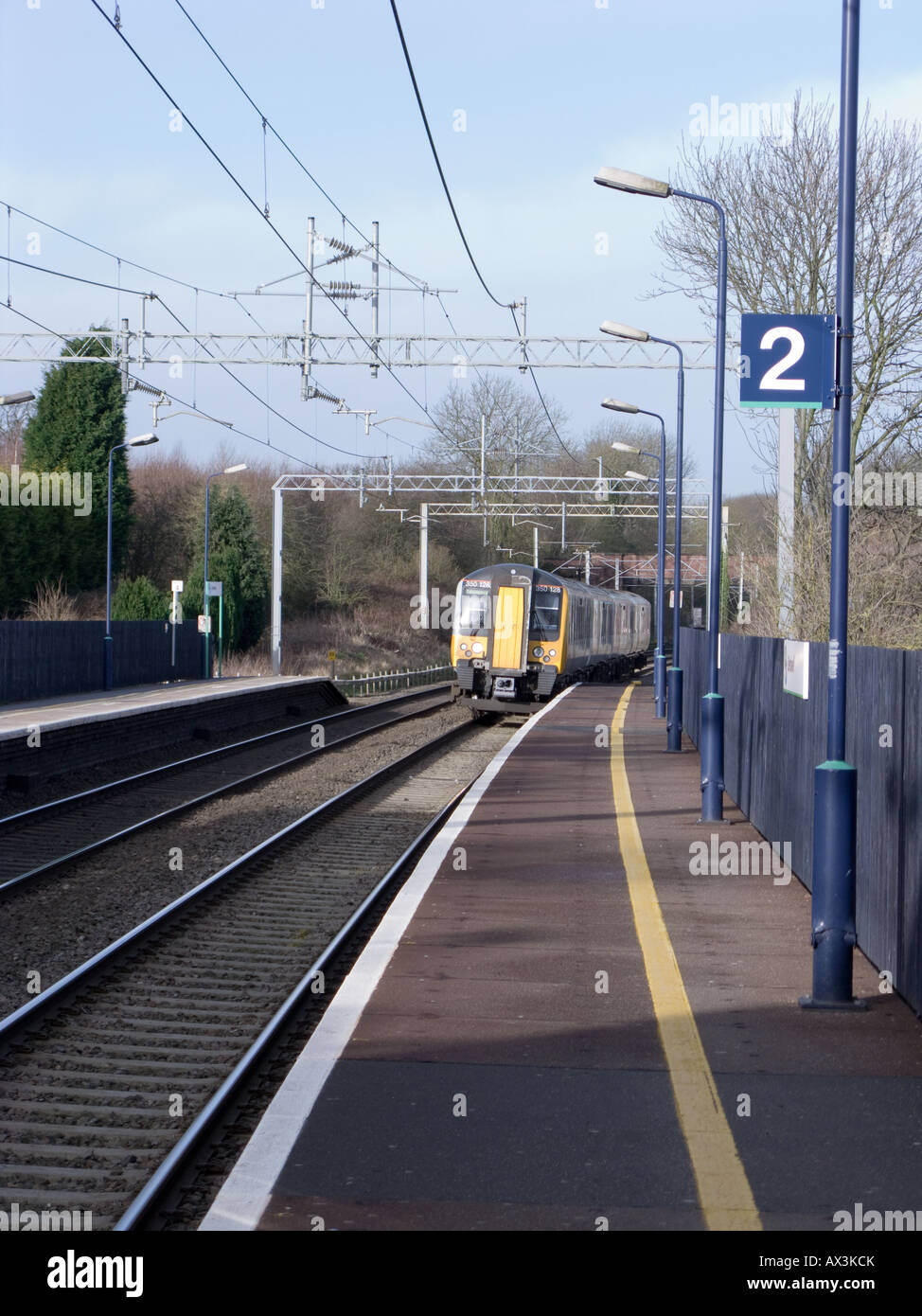 Train arriving at platform Stock Photo - Alamy