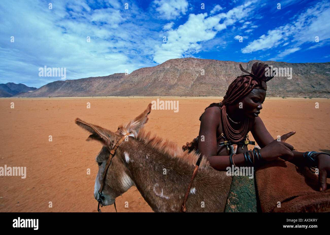 Himba woman with Traditional Leather Dress and Hairdo with donkey in ...
