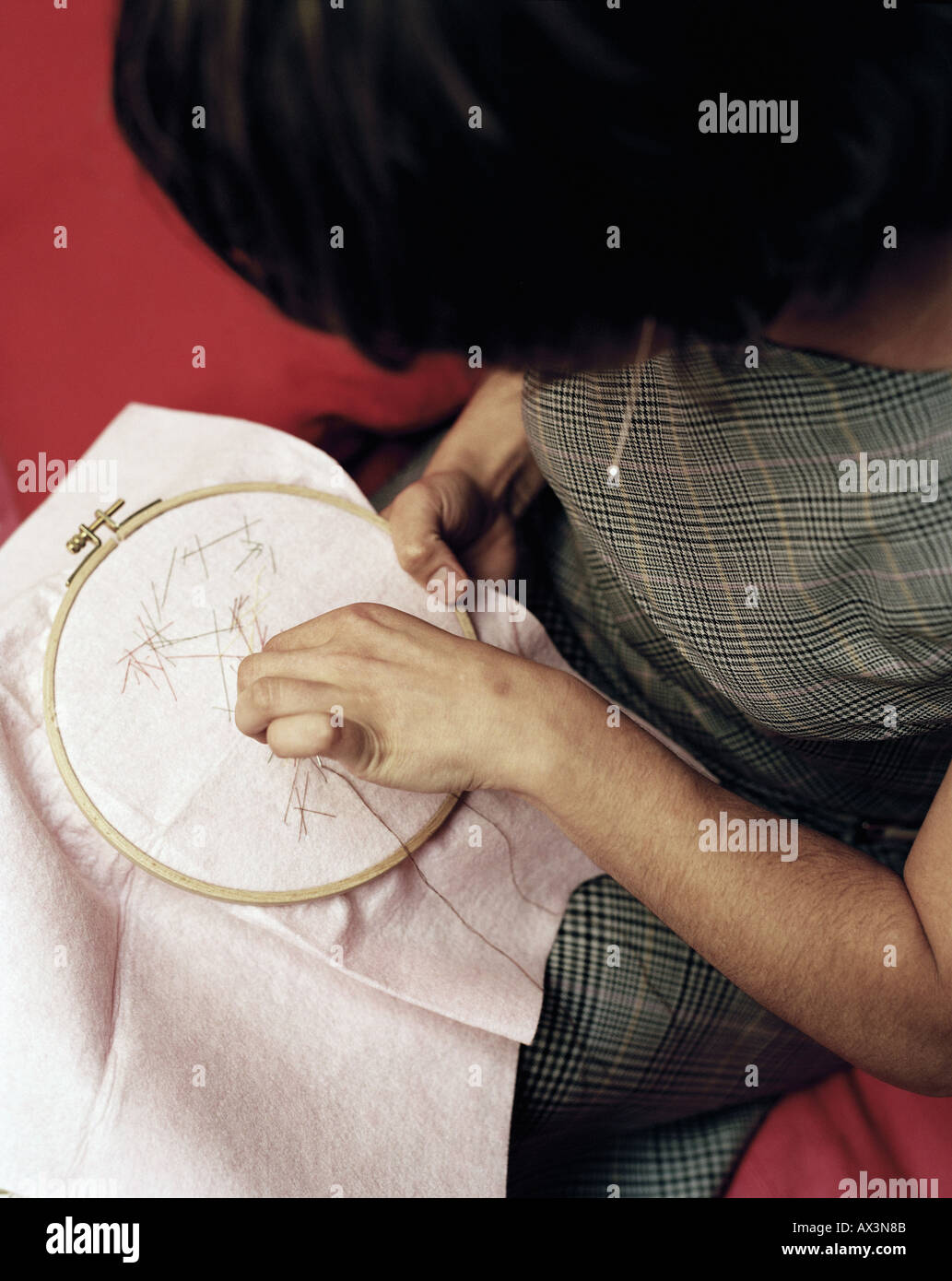 Woman doing needlepoint Stock Photo - Alamy