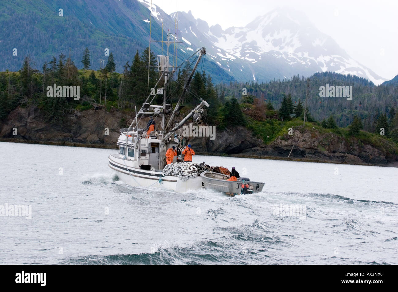 Alaska fishing trawler with snow covered mountains in background Stock ...