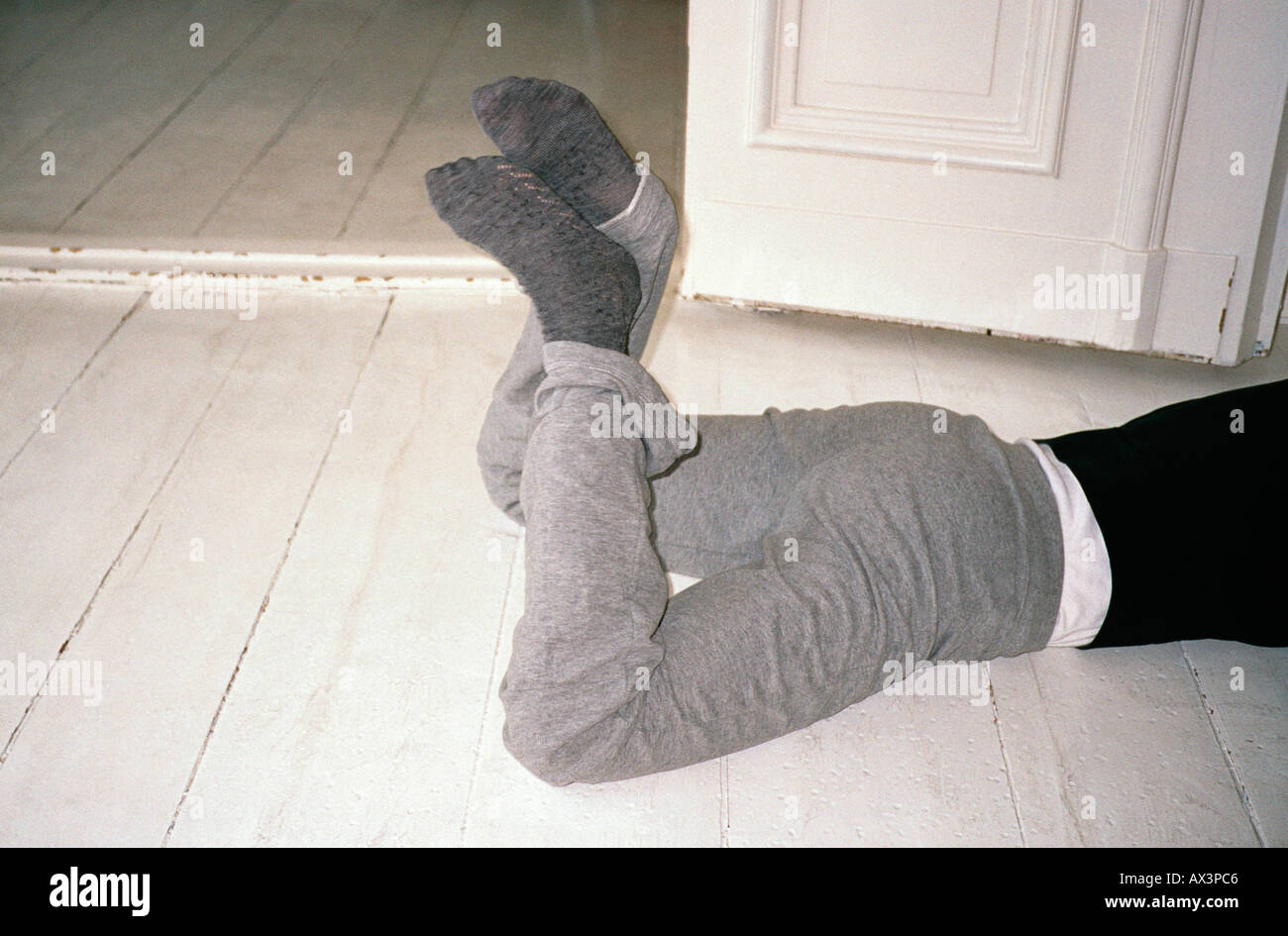 Person lying down on floor Stock Photo - Alamy