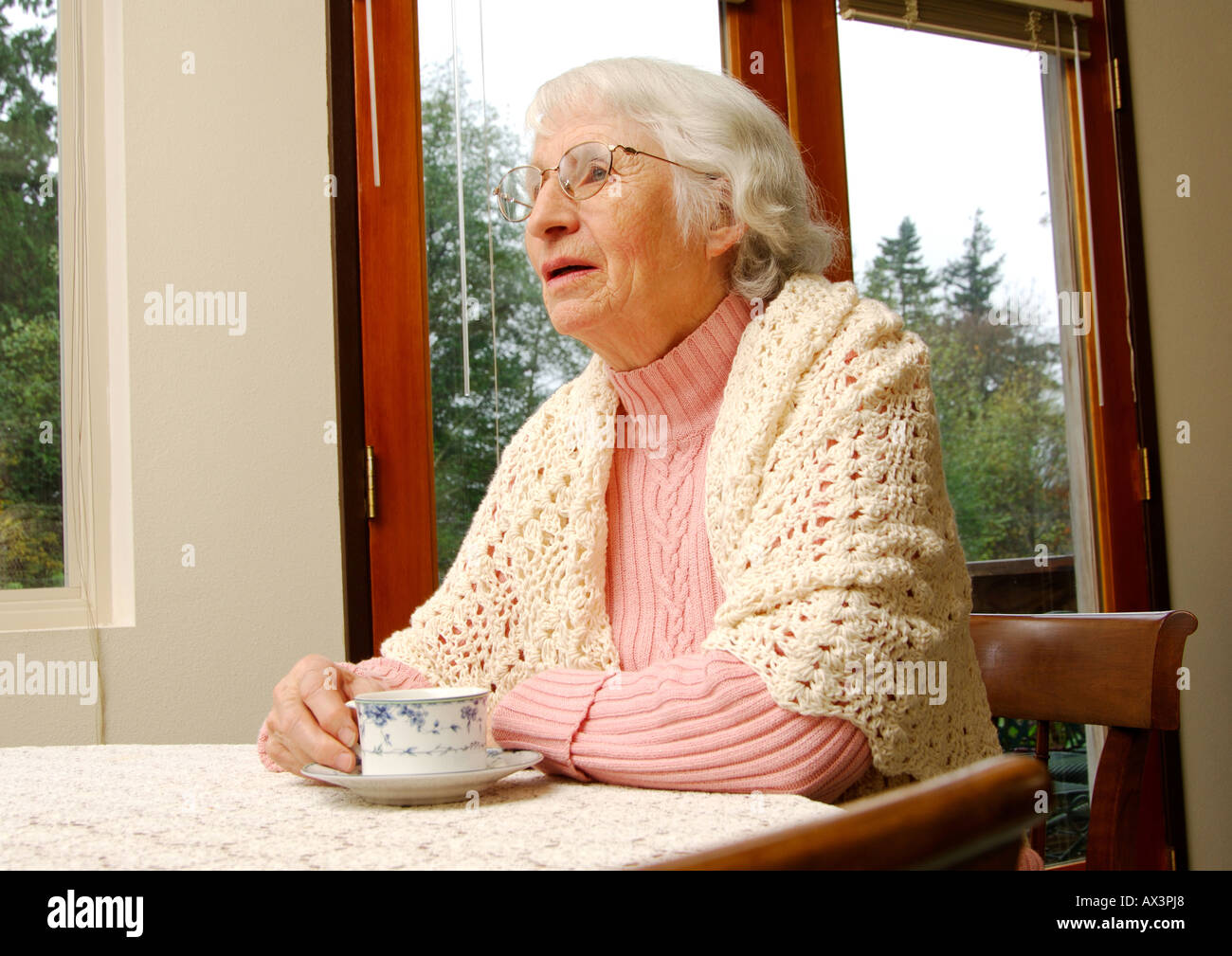 An old woman absorbed in her thoughts Stock Photo - Alamy