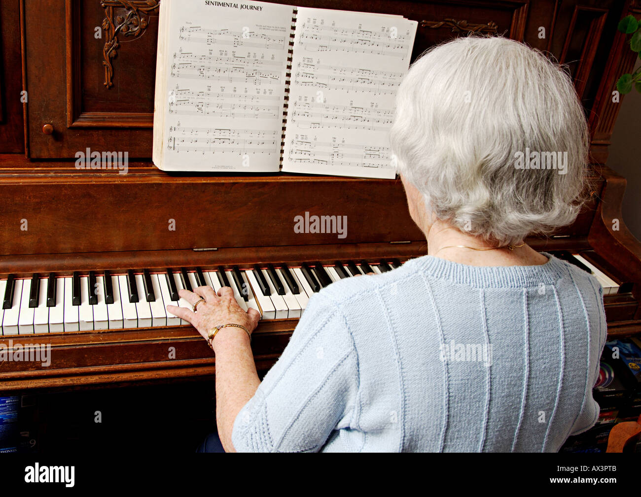 View of an elderly woman playing a piano Stock Photo - Alamy