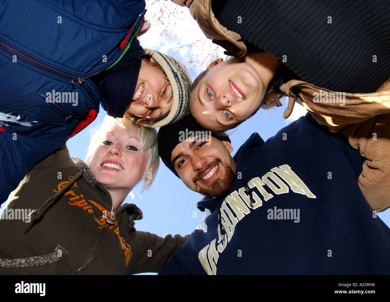 Portrait of four people smiling at the camera Stock Photo - Alamy