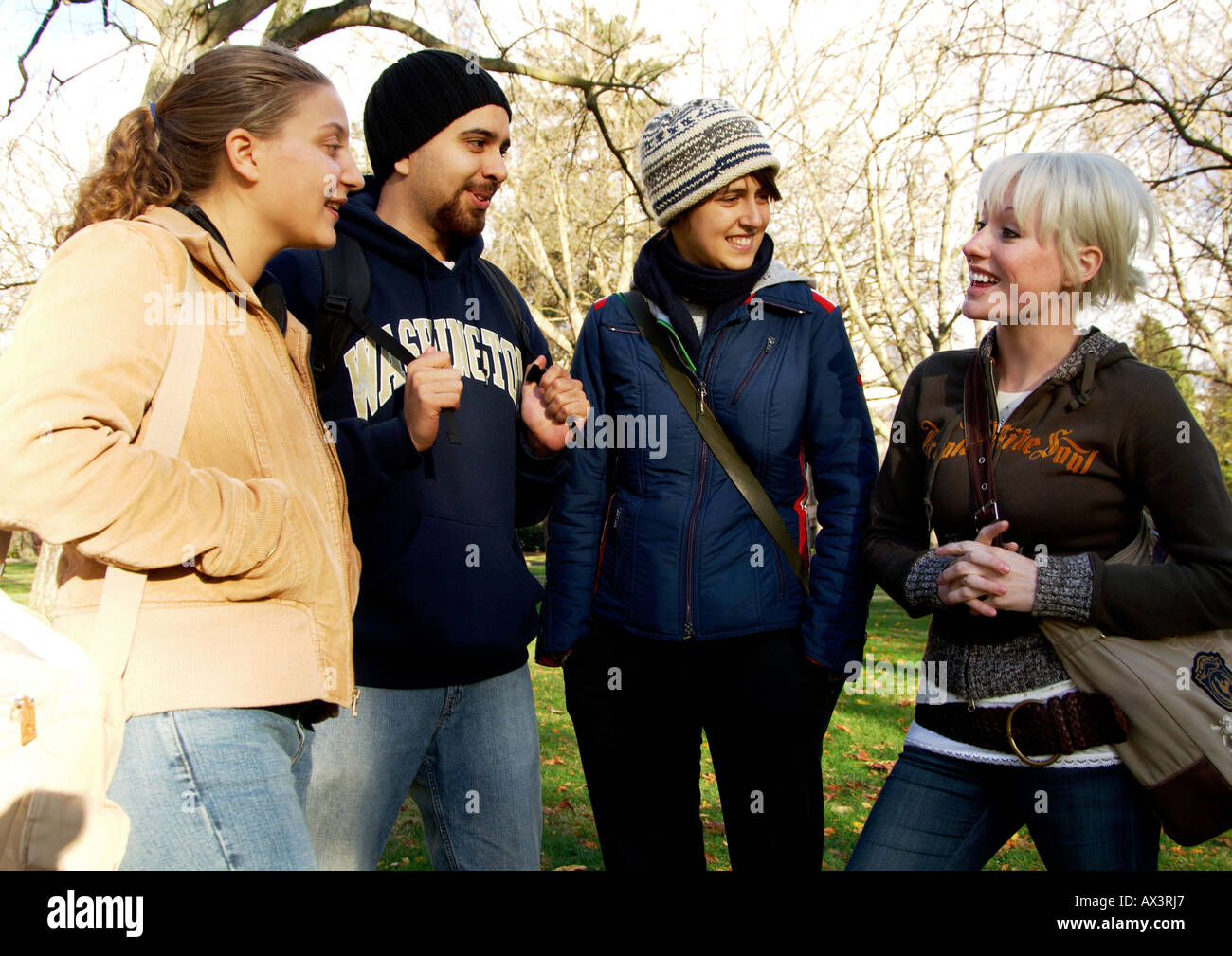 View of four friends spending time together Stock Photo - Alamy