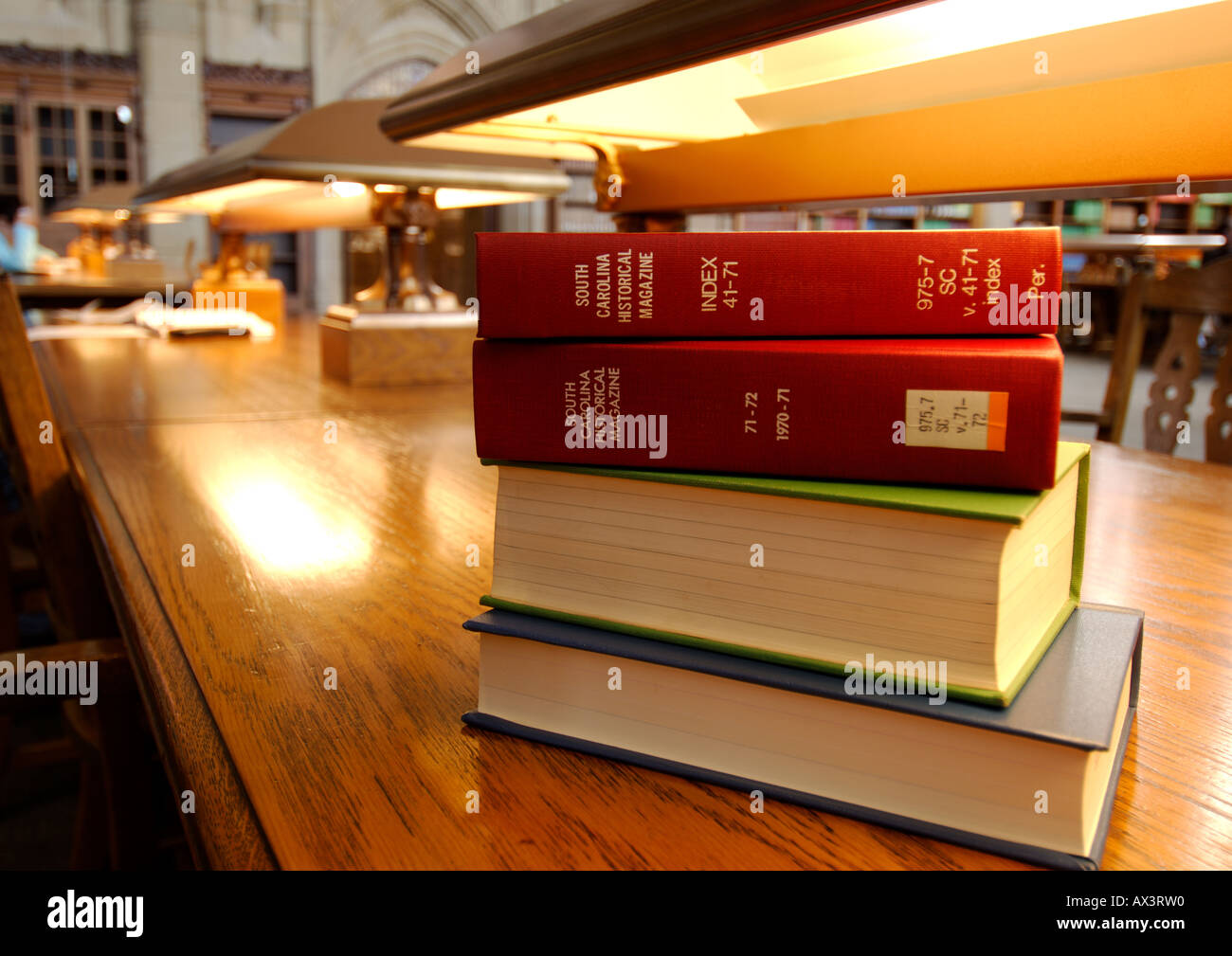 Close up of a stack of books under a reading lamp Stock Photo - Alamy