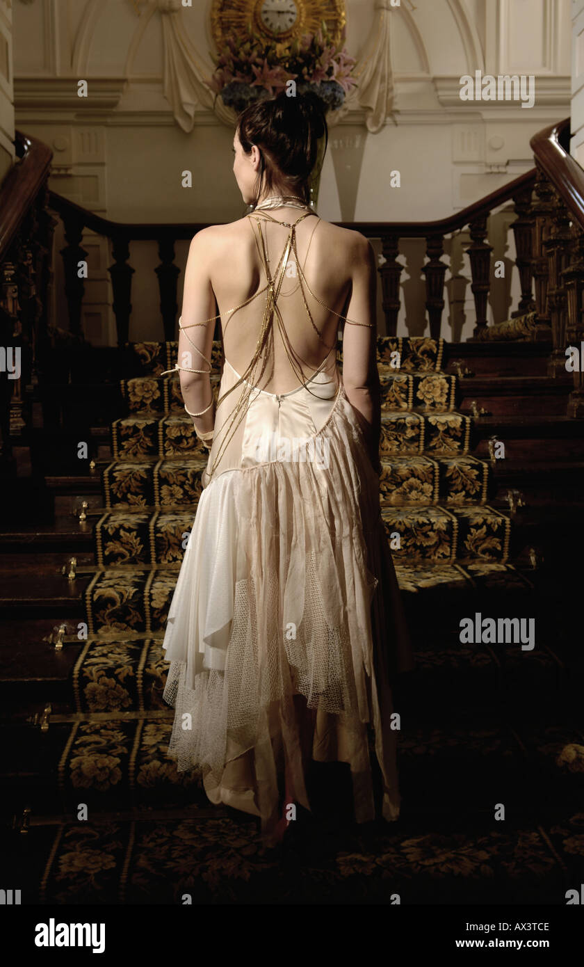Woman in evening gown walking up stairs Stock Photo - Alamy