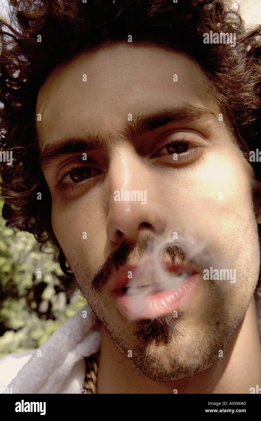 Man blowing smoke Stock Photo - Alamy
