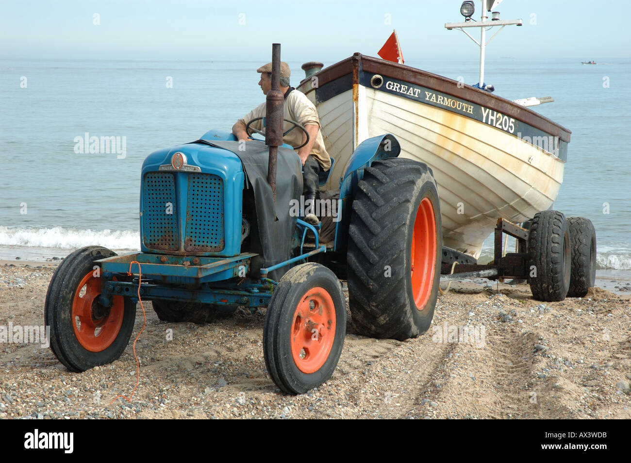 tractor hauling boat onto beach, Cromer, Norfolk, England, UK Stock ...