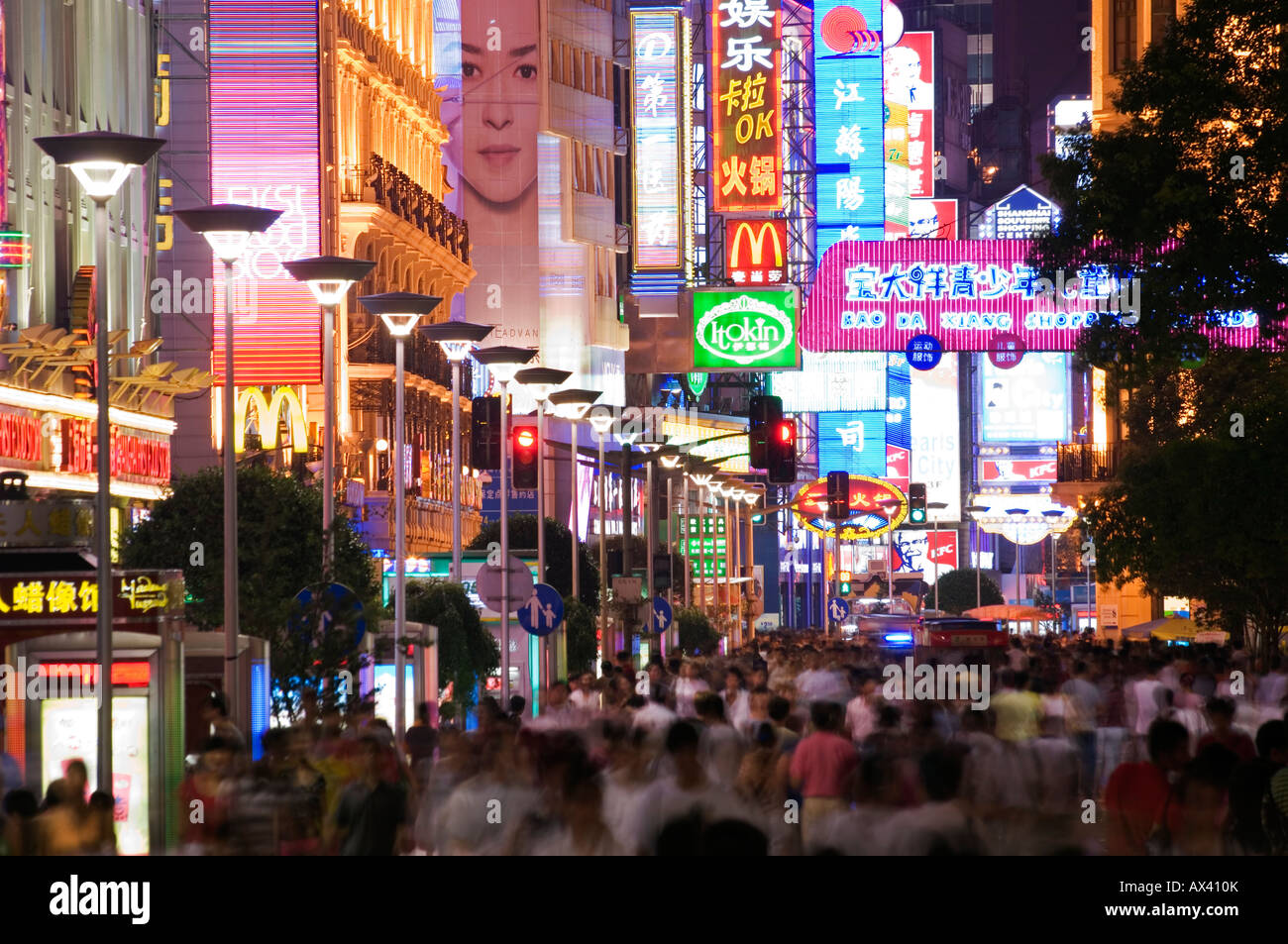 China, Shanghai. Neon signs and pedestrians in Nanjing DongLu road ...