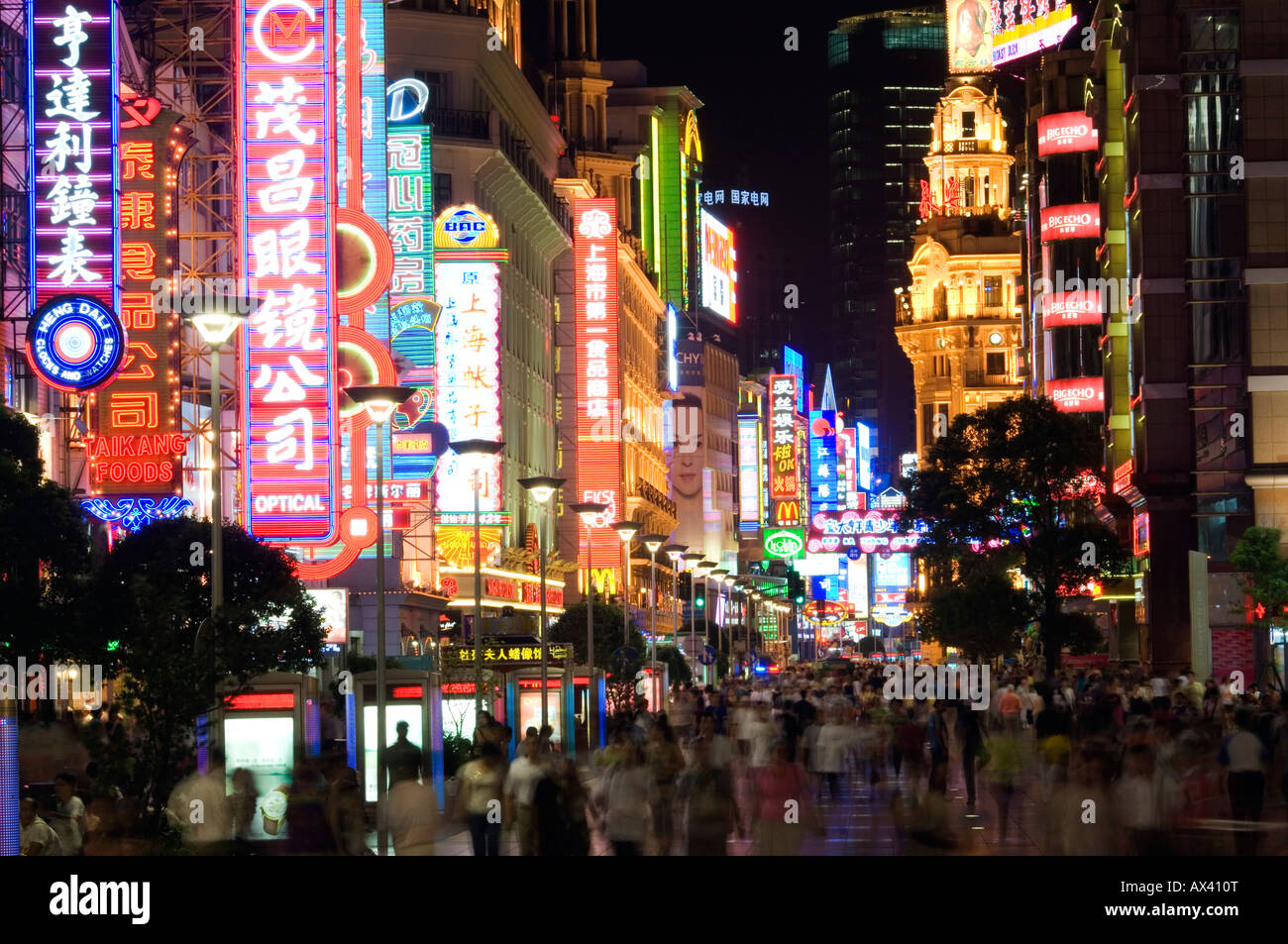 China, Shanghai. Neon signs and pedestrians in Nanjing DongLu road ...