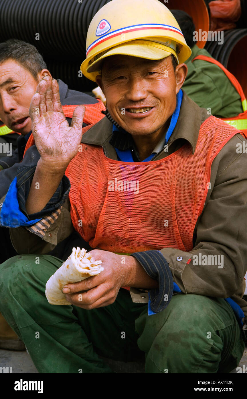 China, Beijing. Construction workers taking a lunch break Stock Photo ...