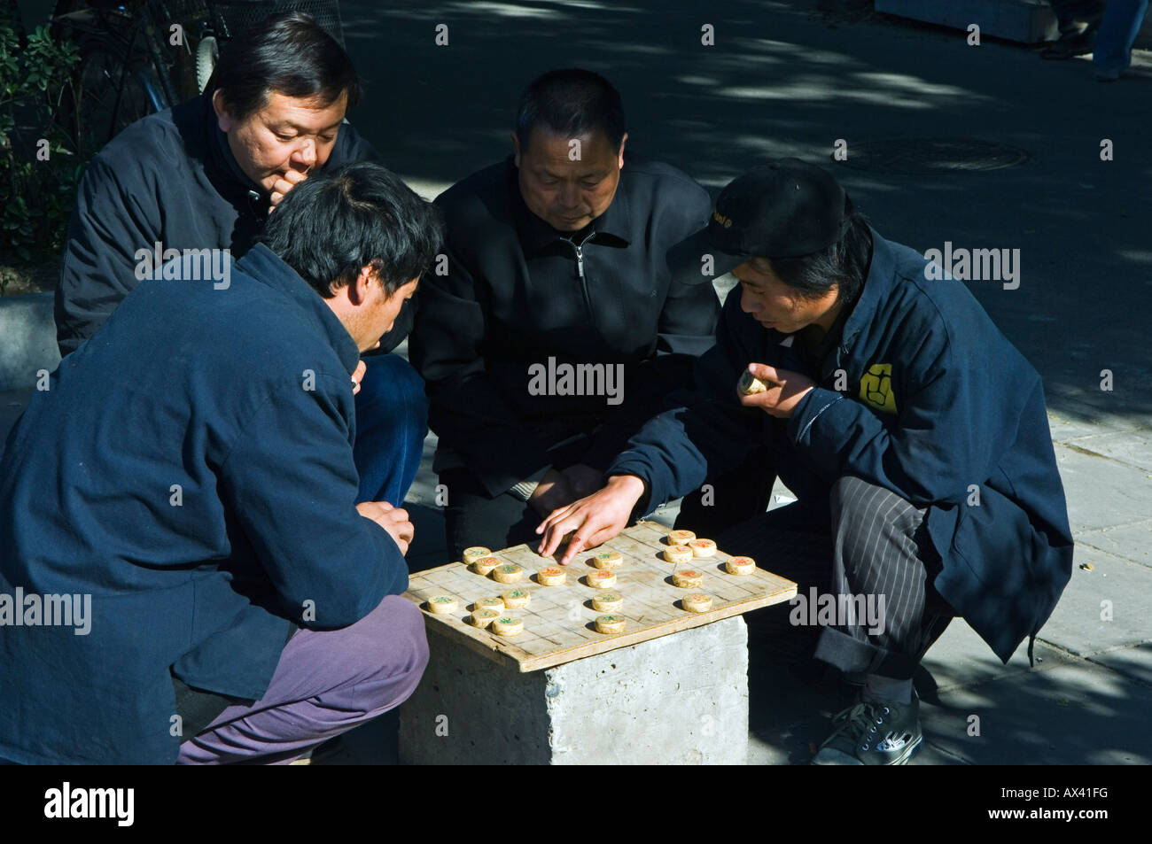 China, Beijing. Men playing Chinese Chess in a local neighbourhood ...
