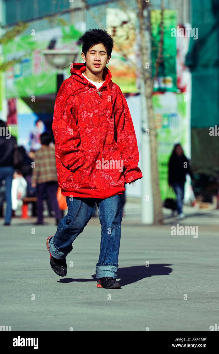China, Beijing. A Chinese boy walking on Wanfujing Shopping street ...