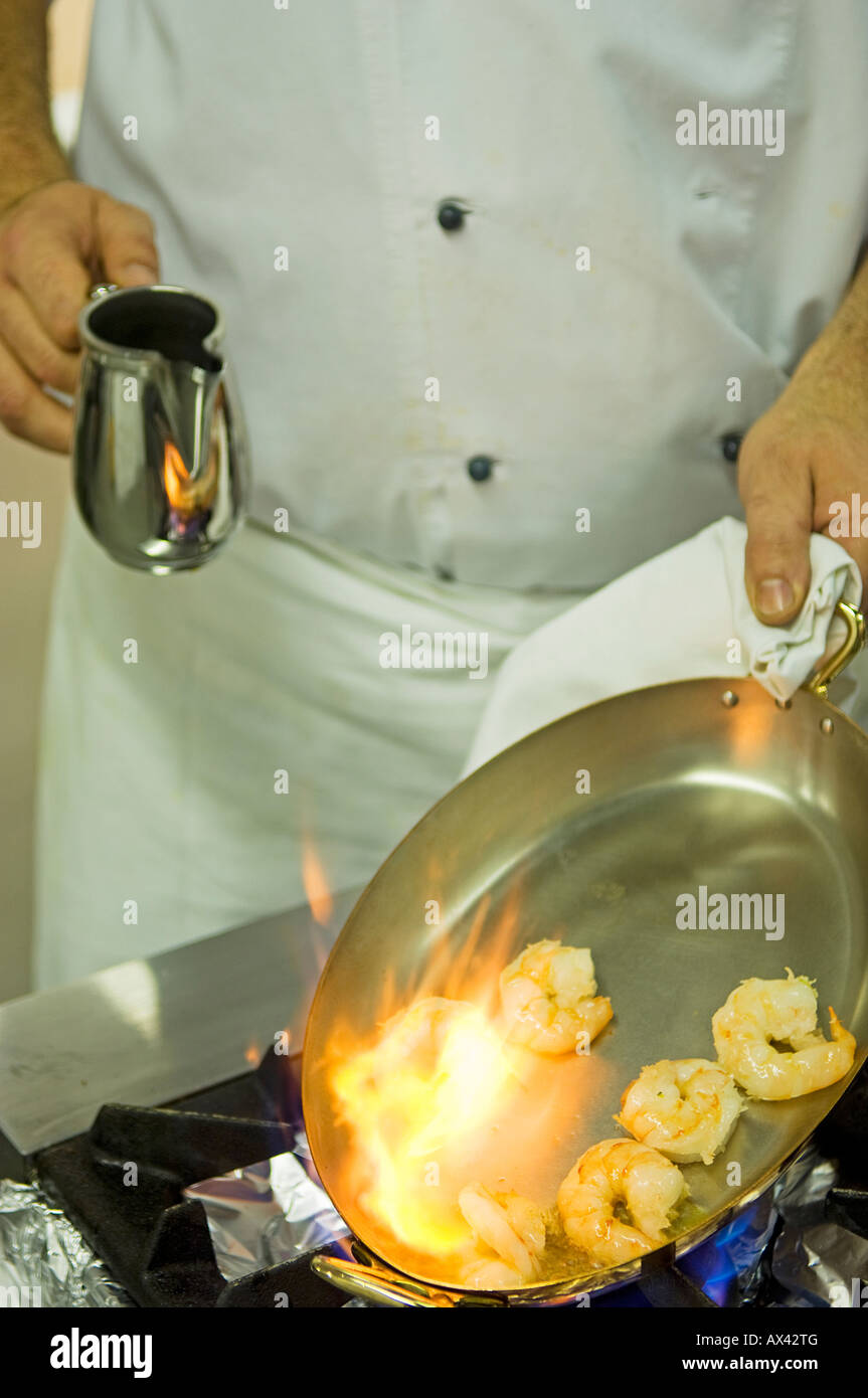 Chef flambeing food in pan hi-res stock photography and images - Alamy