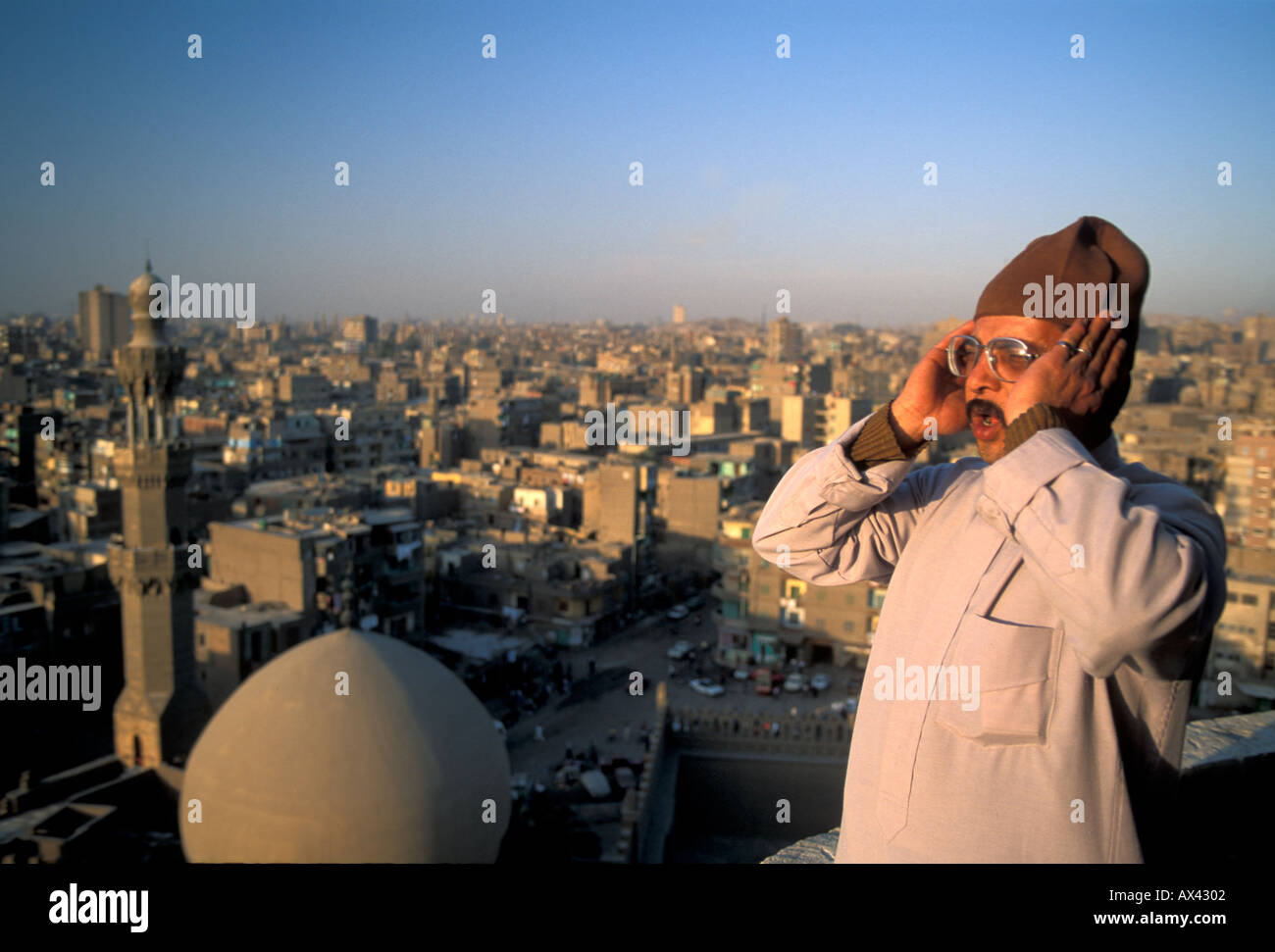 An Imam making the prayer call from the Ibn Tulun Mosque in Cairo ...