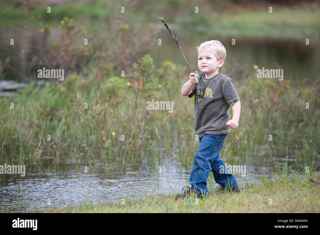 Young Boy with Stick Stock Photo - Alamy
