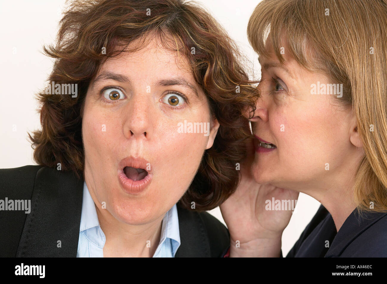 two women whisper a secret in close up of ear and mouth Stock Photo - Alamy