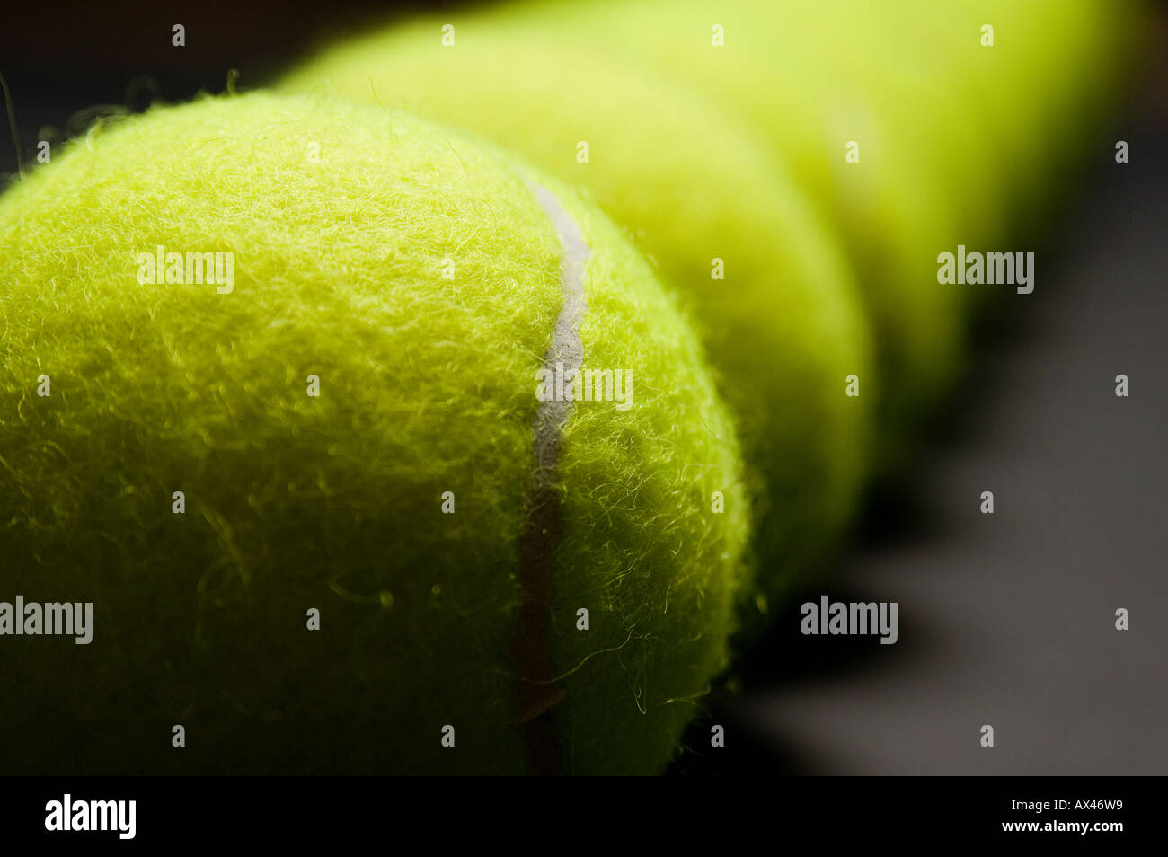 An extreme close up photograph of a line of tennis balls Picture has a ...
