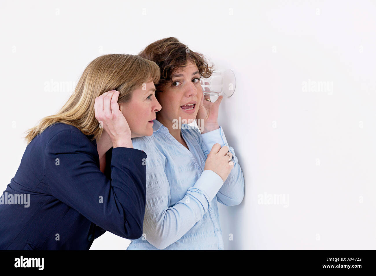 Woman listening conversation through wall hi-res stock photography and ...